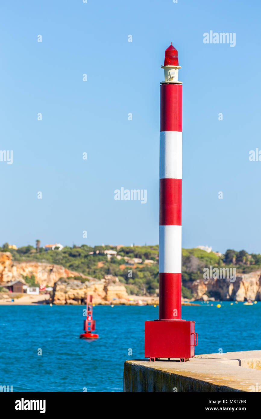 Beacon and buoy with blue water at portuguese coast Stock Photo - Alamy