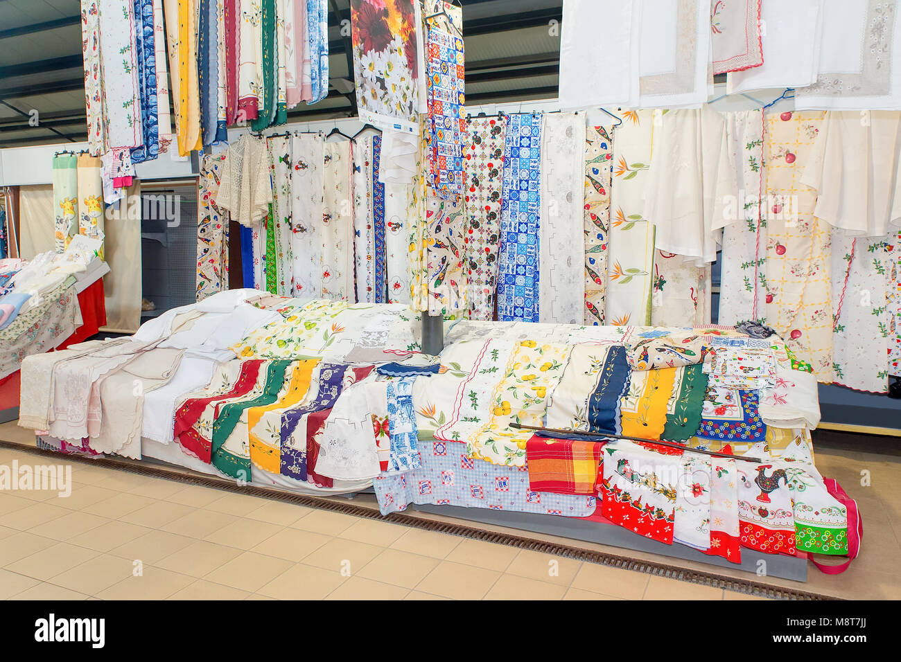 Many spread textiles and fabrics for sale at market Stock Photo - Alamy