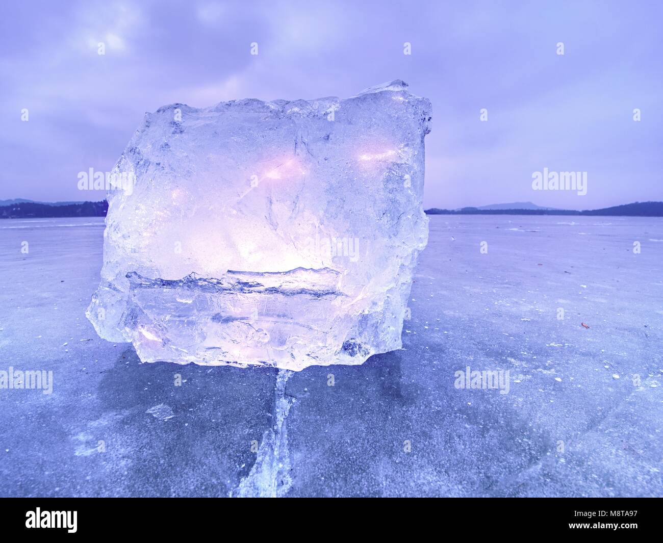 Arctic ice. A large piece of natural ice on a green blue flat ice of ...