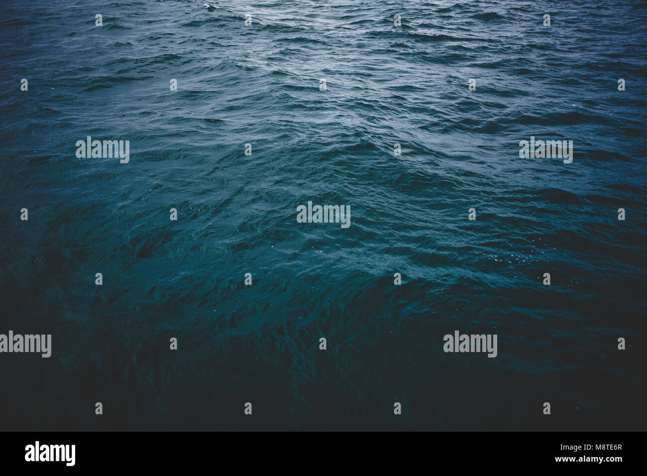 Blue sea surface, top view. Dark mood tone Stock Photo - Alamy