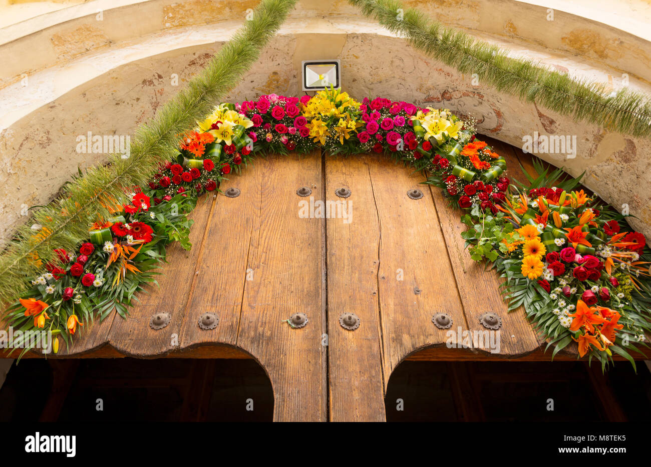Floral archway over Mexican church door Stock Photo - Alamy