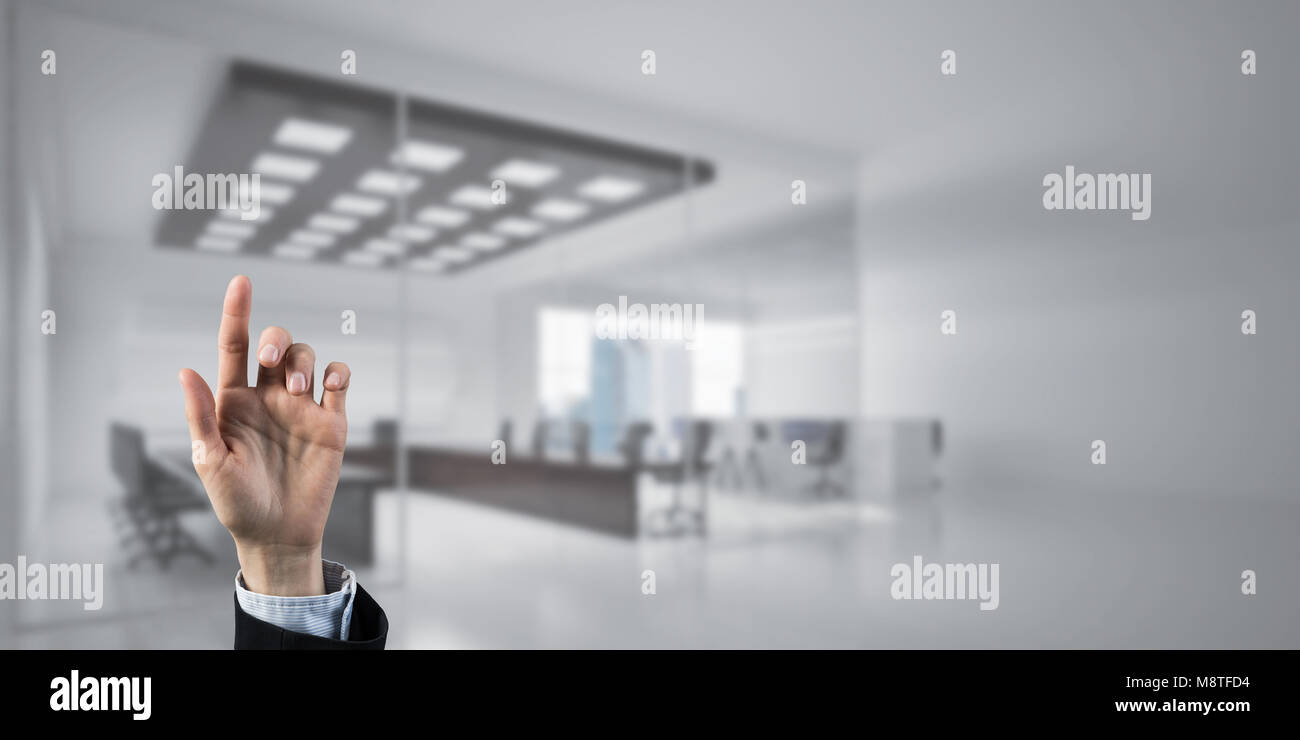 Close of businesswoman hand touching screen with finger and office at ...