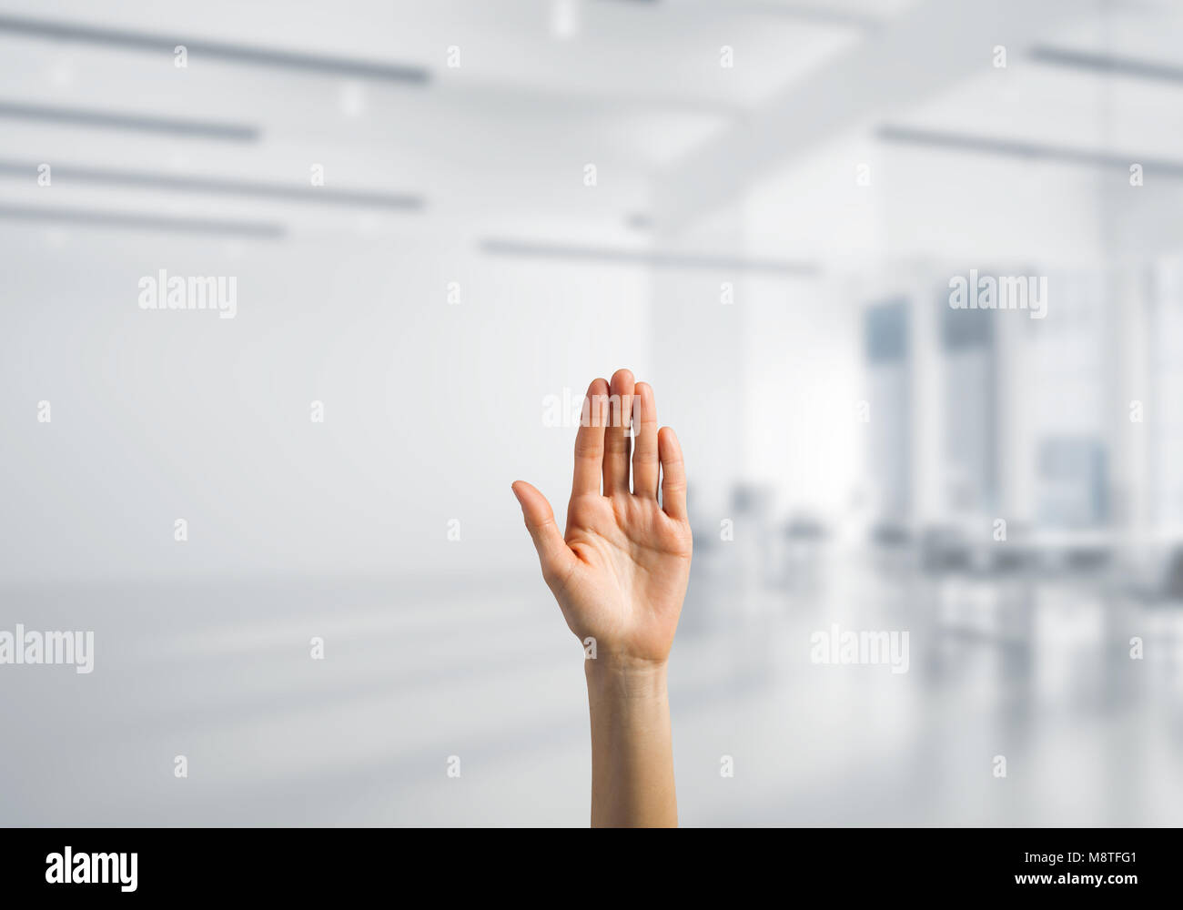 Close of woman hand touching screen with palm and office at background ...