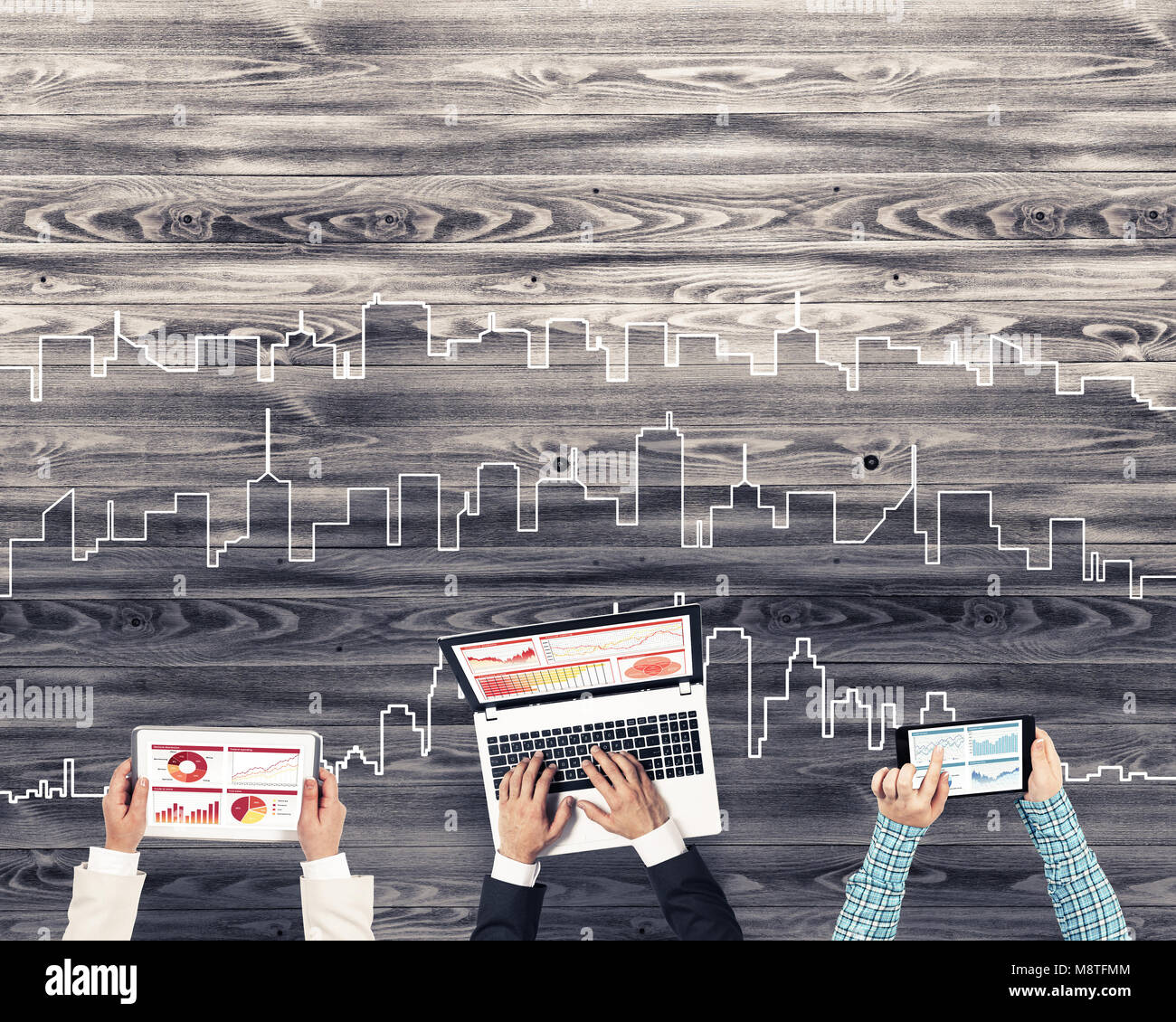 Group of three people with devices in hands working together as symbol ...