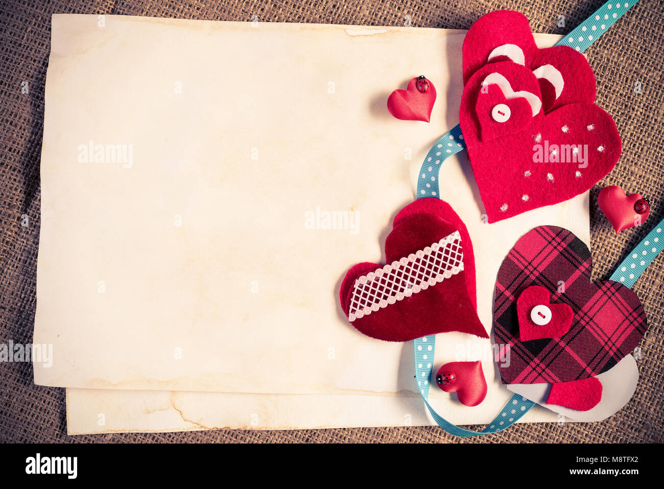 Handmade love hearts and sheets of blank paper Stock Photo - Alamy