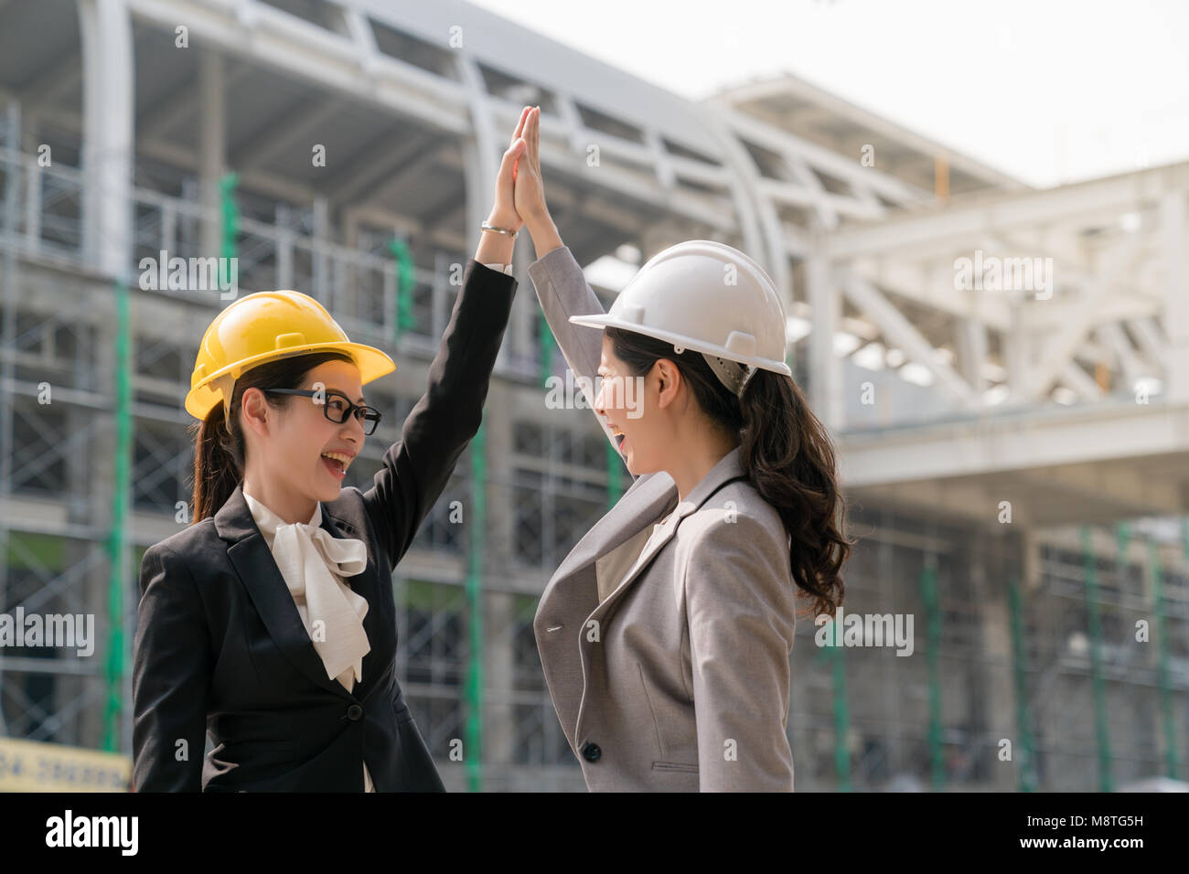 Two woman engineer clapping the hands showing their happiness and ...