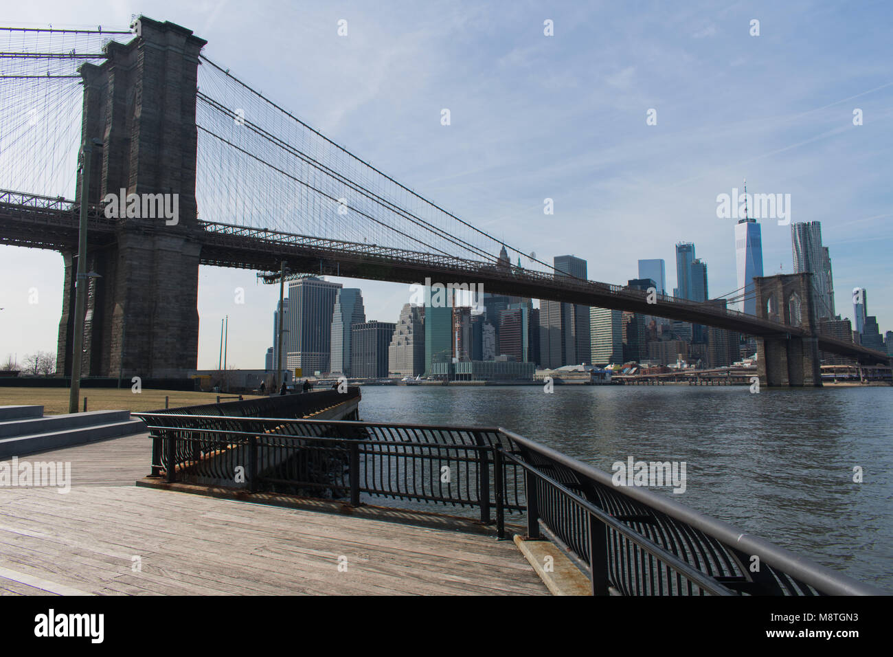A view of New York City skyline from the DUMBO park, with lovely blue ...