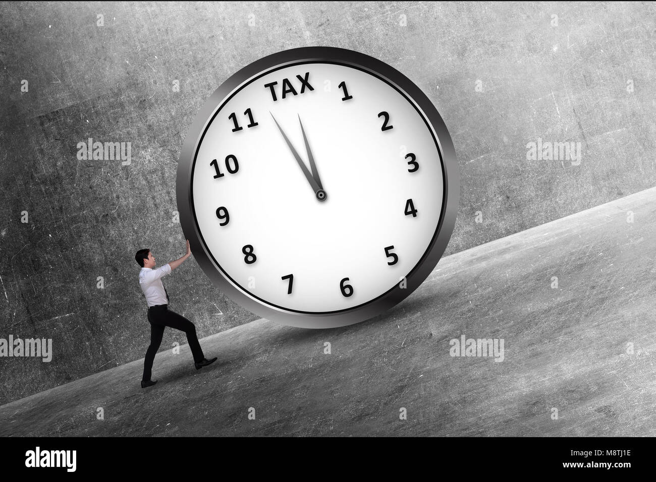 Handsome asian businessman pushing on the clock with tax message. Goods ...