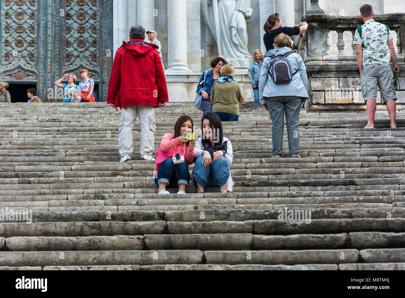 Two girls sitting on stairs hi-res stock photography and images - Alamy