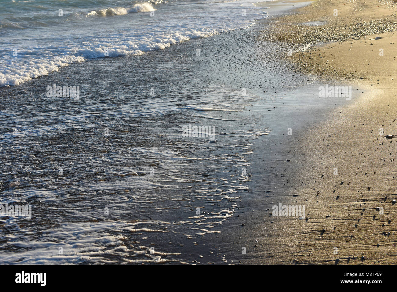 Ocean waves approaching sandy beach. Summer holiday concept Stock Photo ...