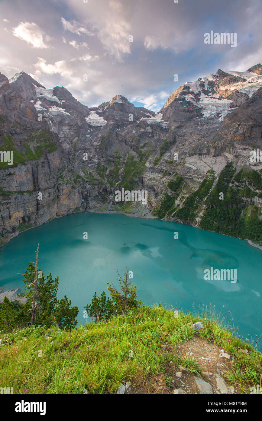 Spectacular view from a high ledge, cliff of an alpine lake at sunrise ...