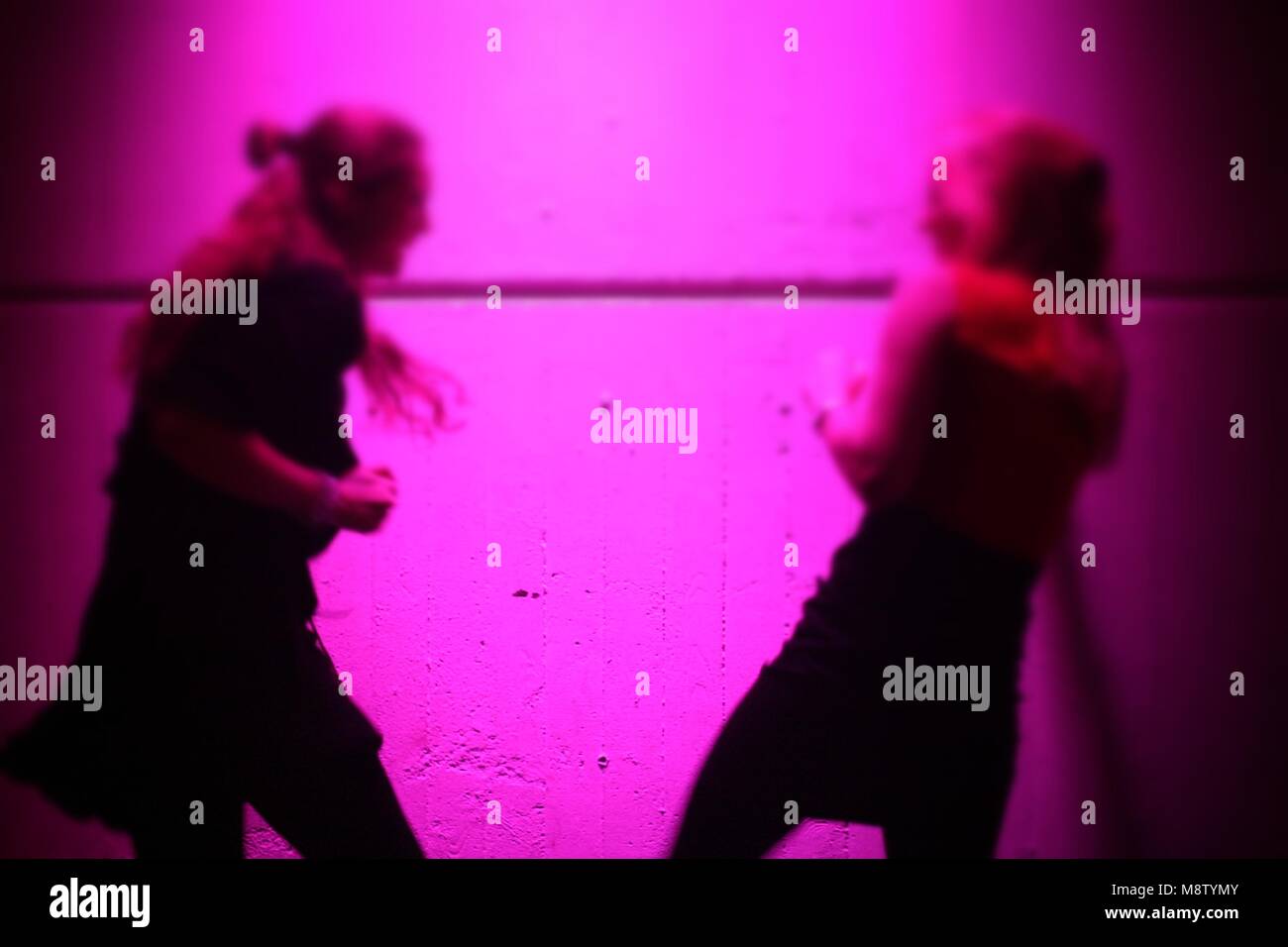 Aggressive anger female teenagers in pink light blur effect Stock Photo ...