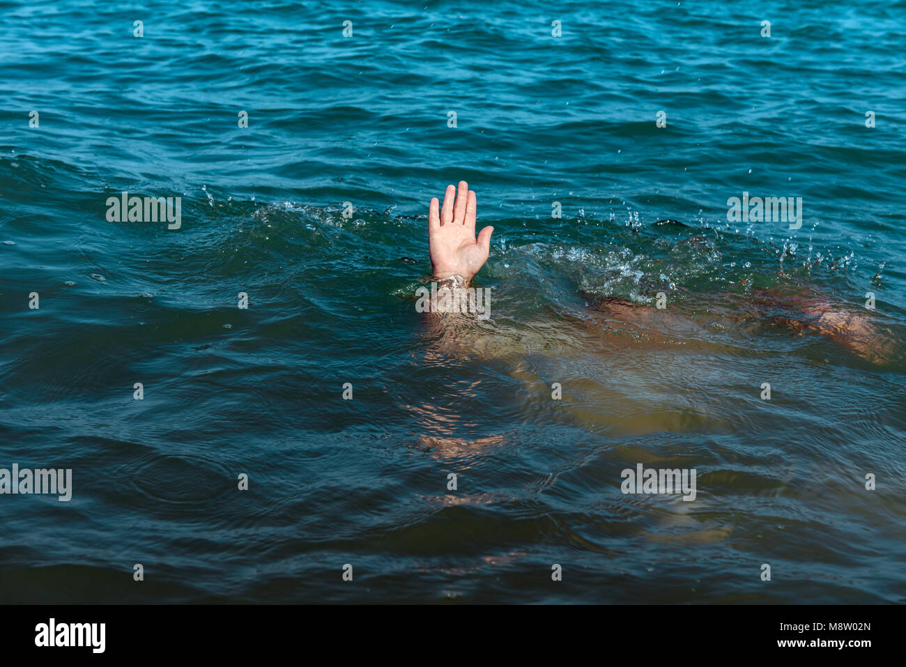 A sinking person, the salvation of a drowning man Stock Photo - Alamy