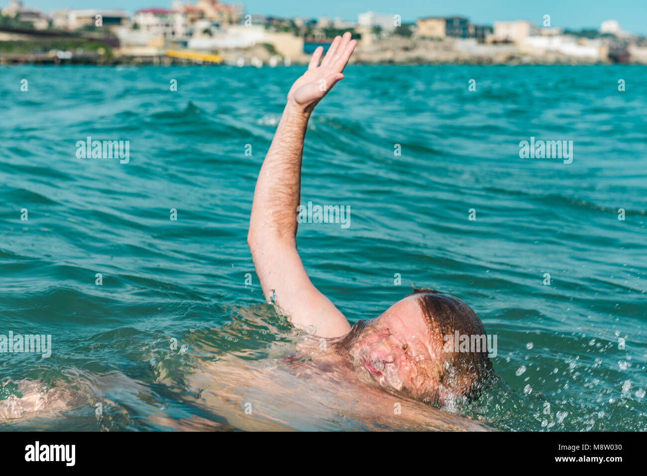 A sinking person, the salvation of a drowning man Stock Photo - Alamy