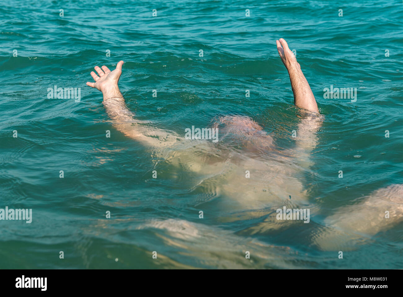 A sinking person, the salvation of a drowning man Stock Photo - Alamy