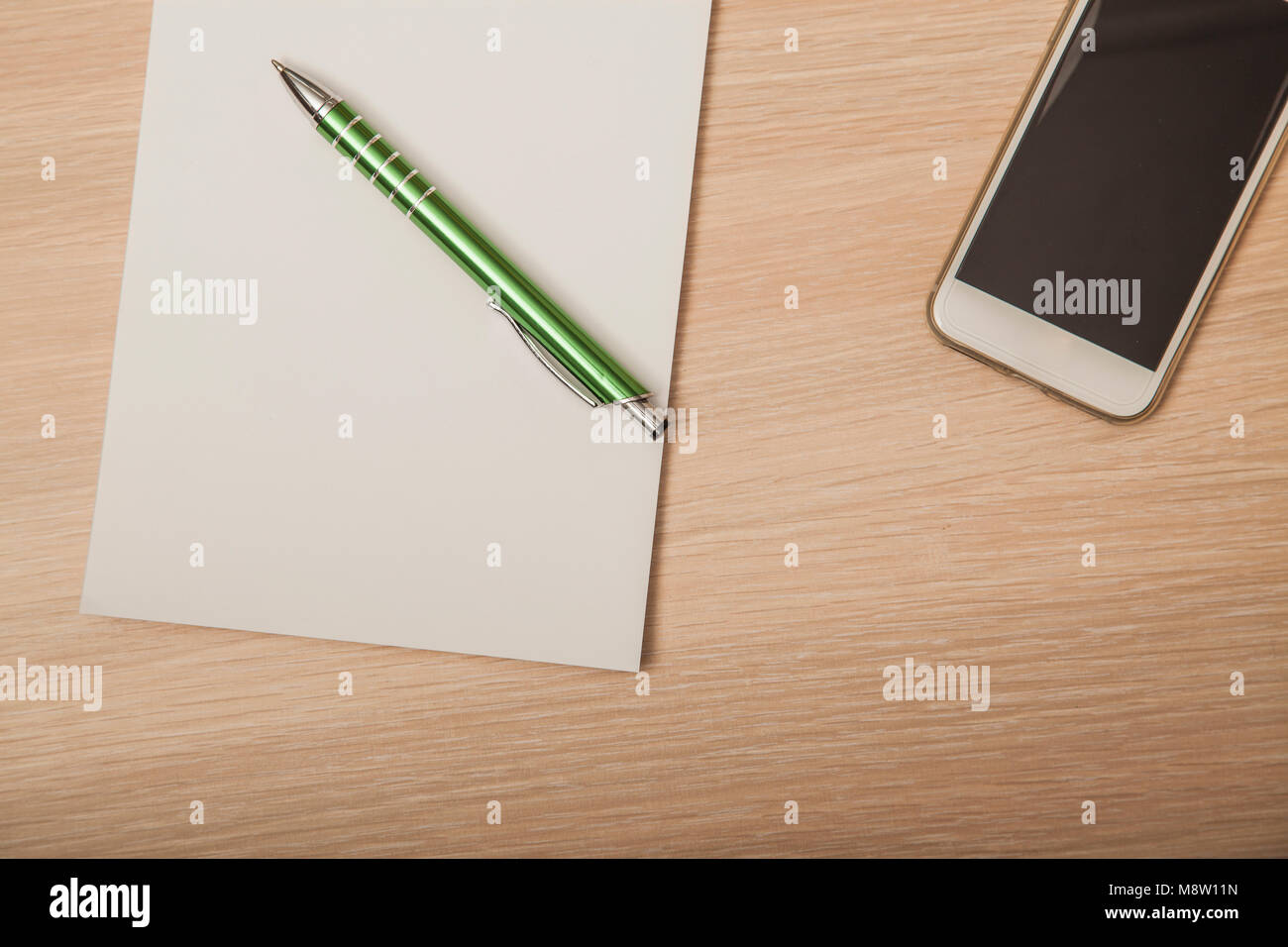 wooden desk with a notebook, top view, empty paper Stock Photo - Alamy