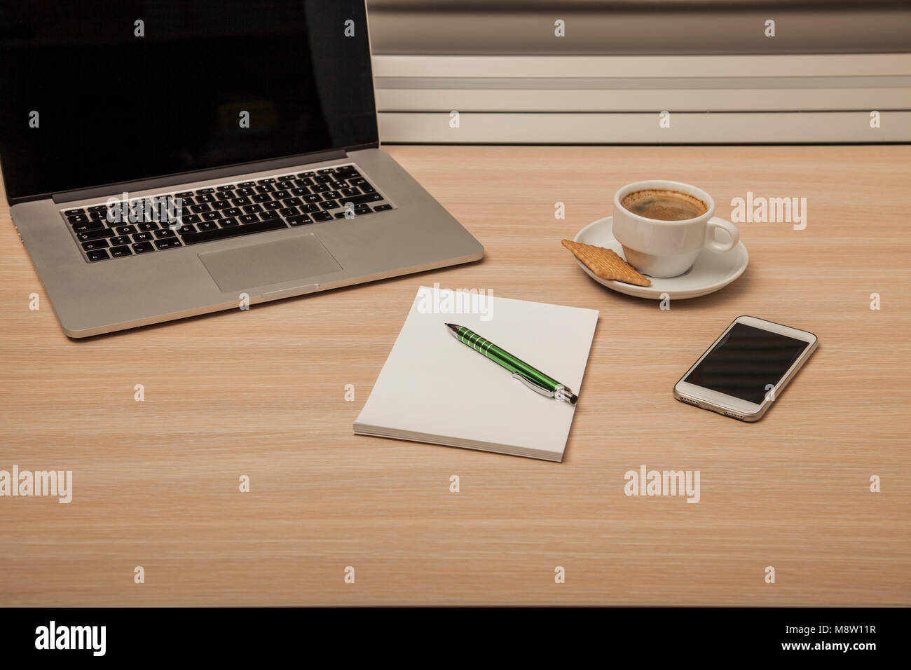 wooden desk with a notebook, front view Stock Photo - Alamy