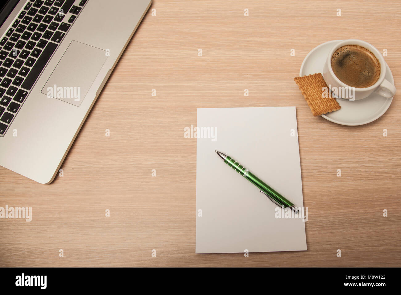 wooden desk with a notebook, top view Stock Photo - Alamy
