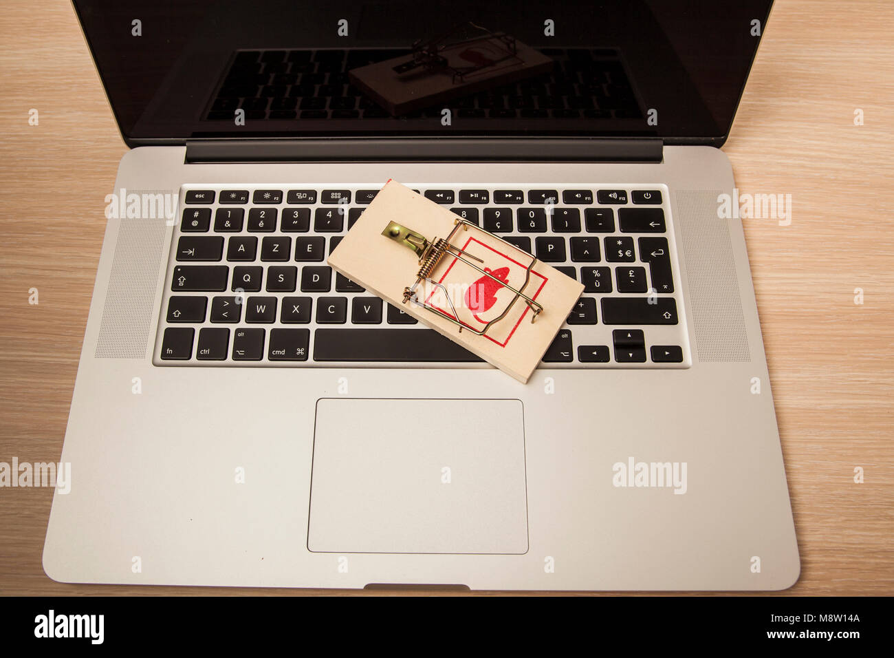 Conceptual photo, a trap set on your computer as a risk of using the ...