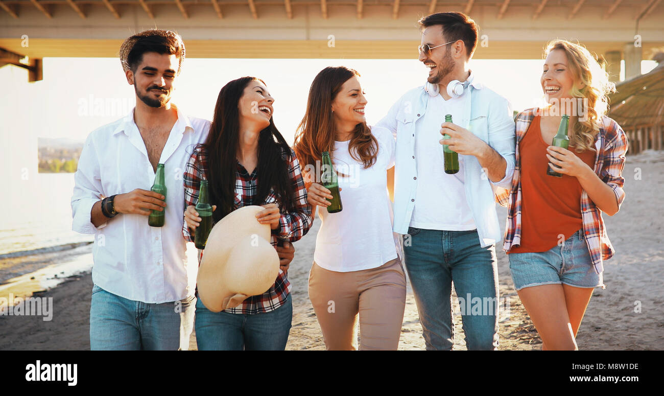 Group of happy friends partying on beach Stock Photo - Alamy