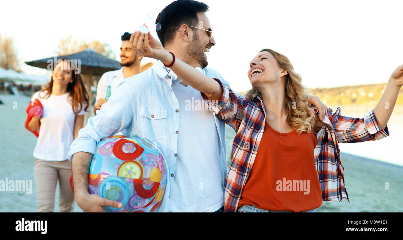 Group of happy friends partying on beach Stock Photo - Alamy