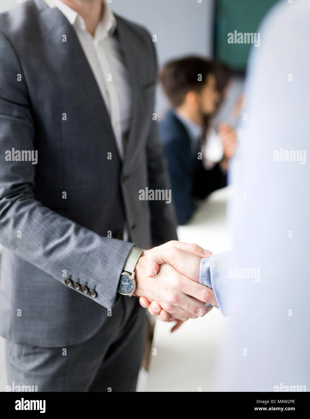 Business people shaking hands in modern office Stock Photo - Alamy
