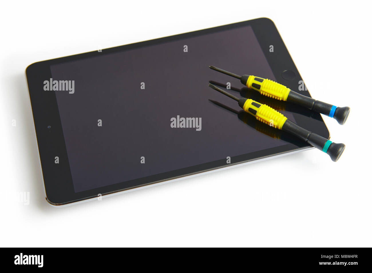 Tablet and screwdrivers. Technology service. Broken device isolated on ...