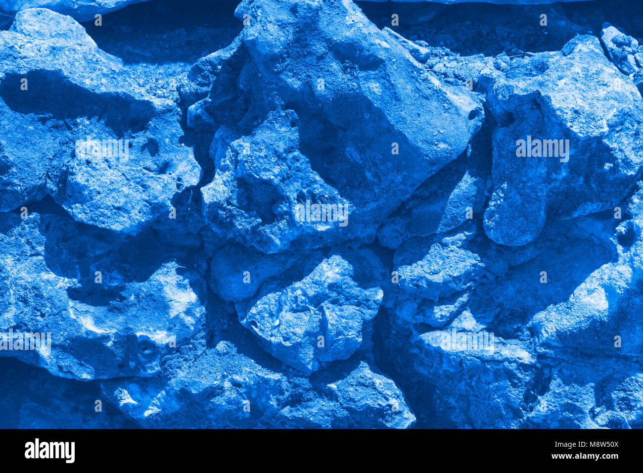 Horizontal stone wall of a nature rock - close up. Toning in pantone ...