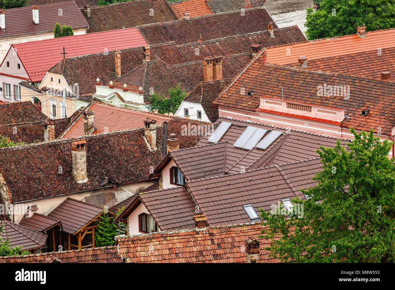 Terracotta tiled roofs with chimneys and dormer windows of city or town ...