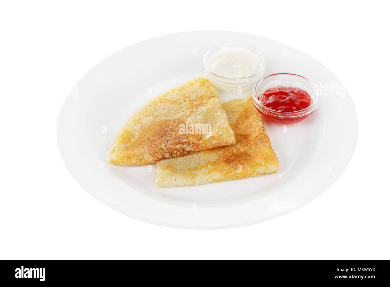 Two pancakes triangle with berry jam and sour cream, isolated white ...