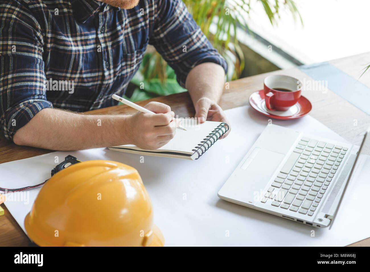 Engineer working in office and drinking coffee Stock Photo - Alamy