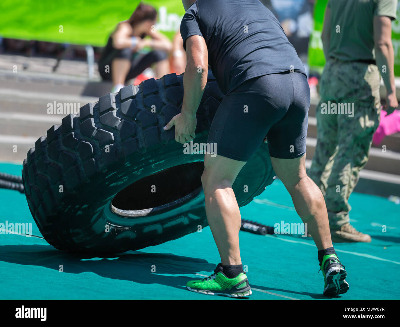 Muscular Man Training: Soldiers Lift Huge and Heavy Truck Tire Stock ...