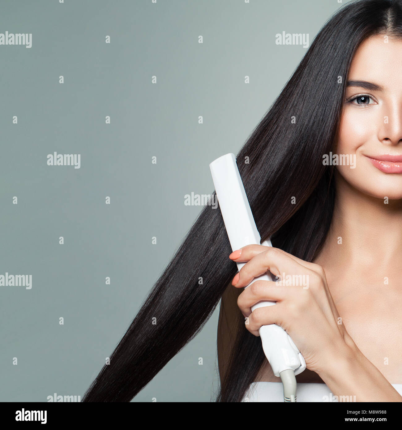 Beautiful Woman with Long Straight Hair Using Hair Straightener. Cute ...