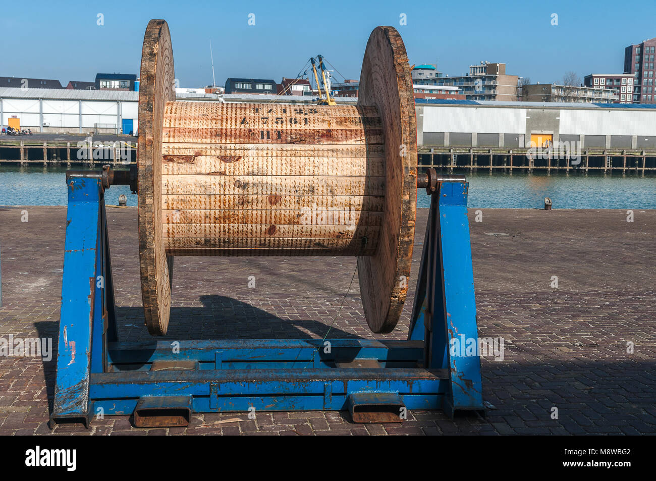 large wooden pulley on a steel platform at the quay of the port Stock ...