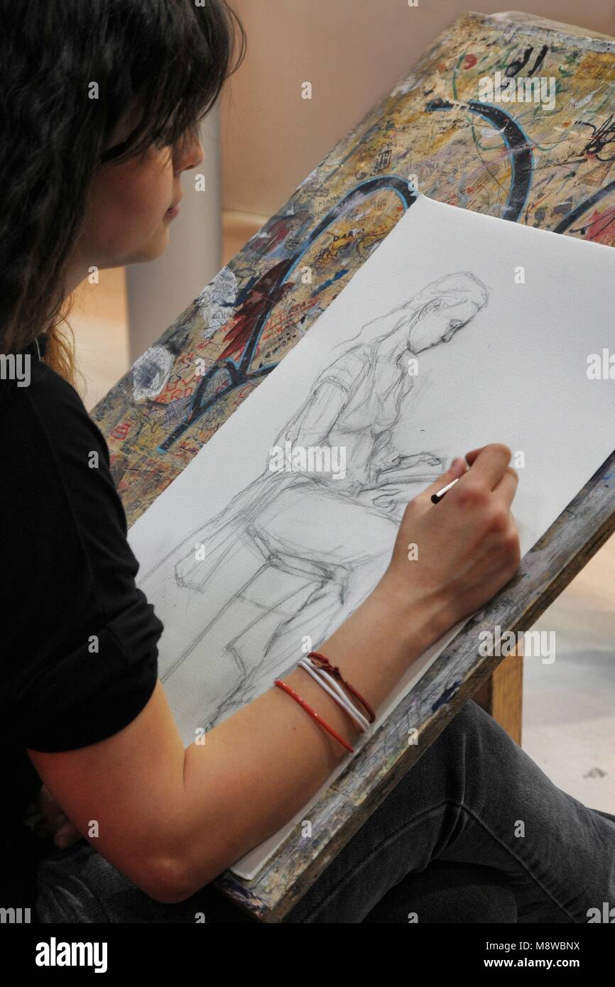 Art student close-up hand and profile at desk drawing with pencil Turin ...
