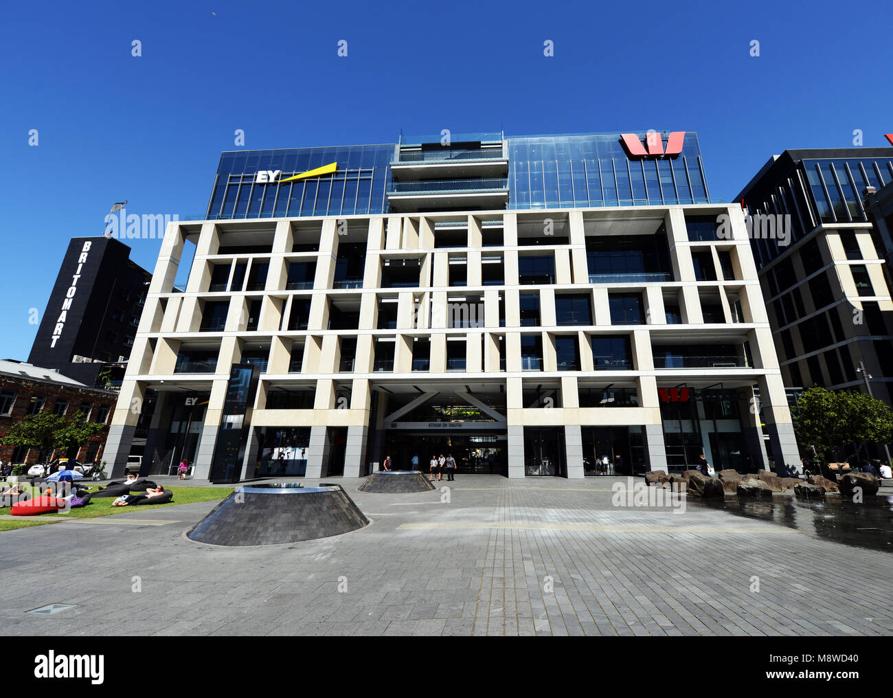 Locals relaxing on the Takutai Lawn at the Talitao square in Auckland's ...