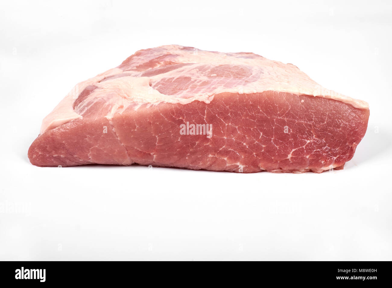 A large piece of pork isolated on white Stock Photo - Alamy
