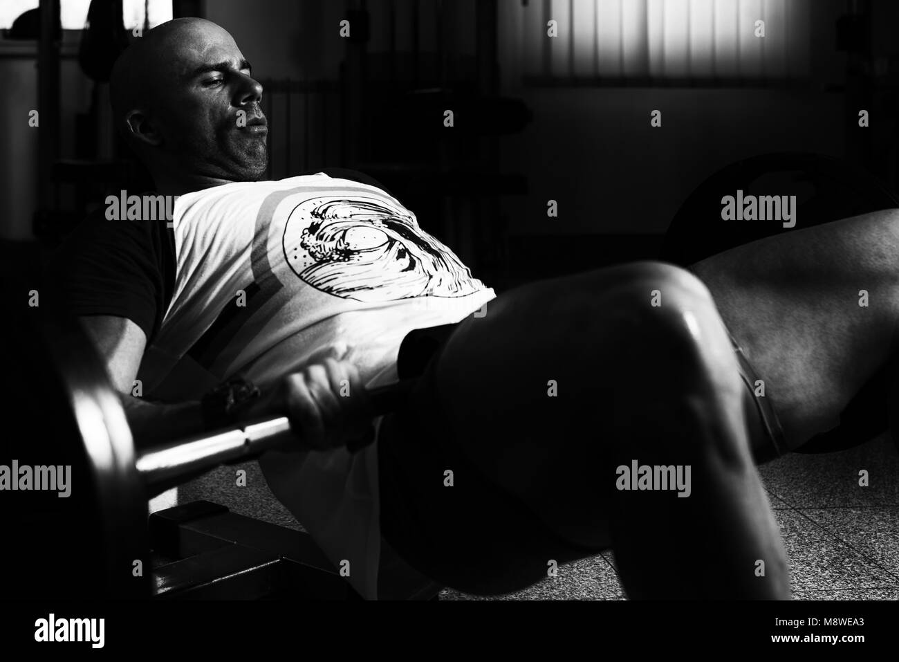 Strong Man In The Gym Exercising Hamstrings With Barbell - Muscular ...