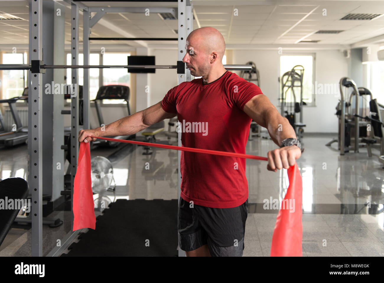 Strong young man stretching muscles hi-res stock photography and images ...