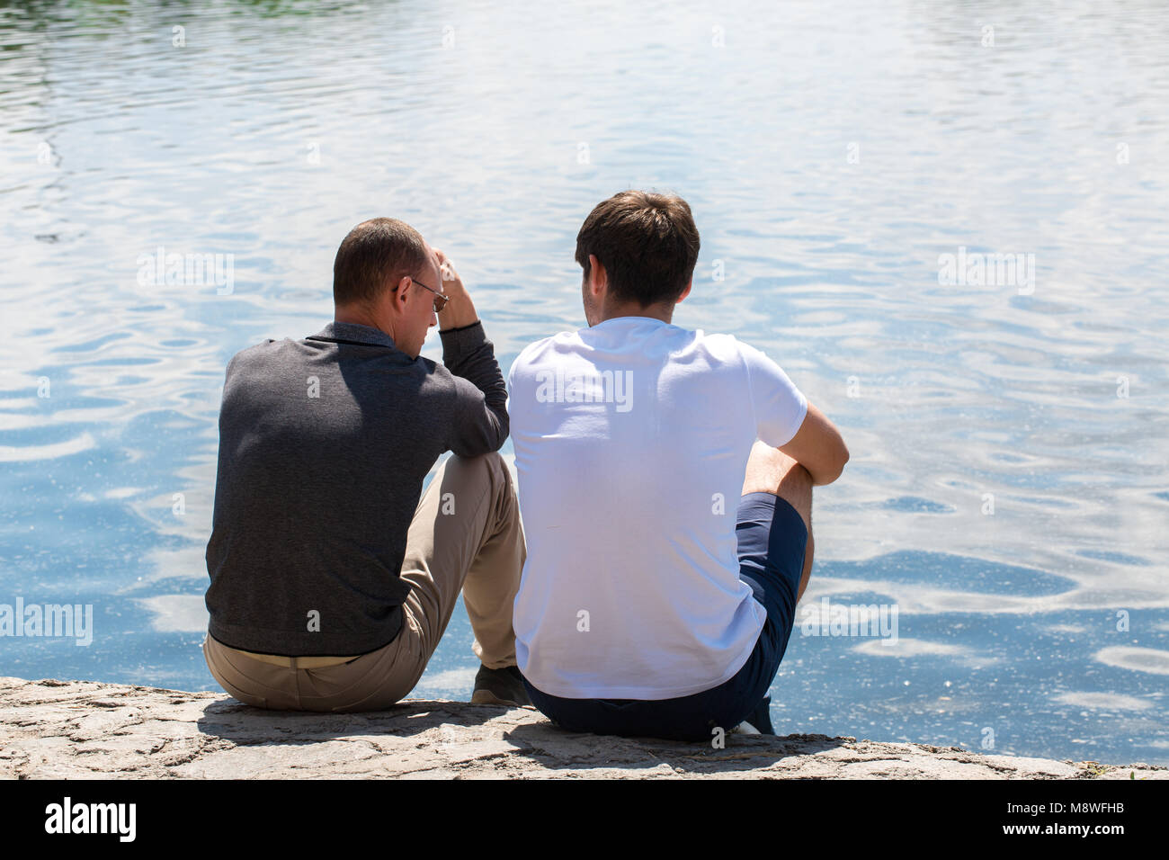 friends communicate by the river Stock Photo - Alamy