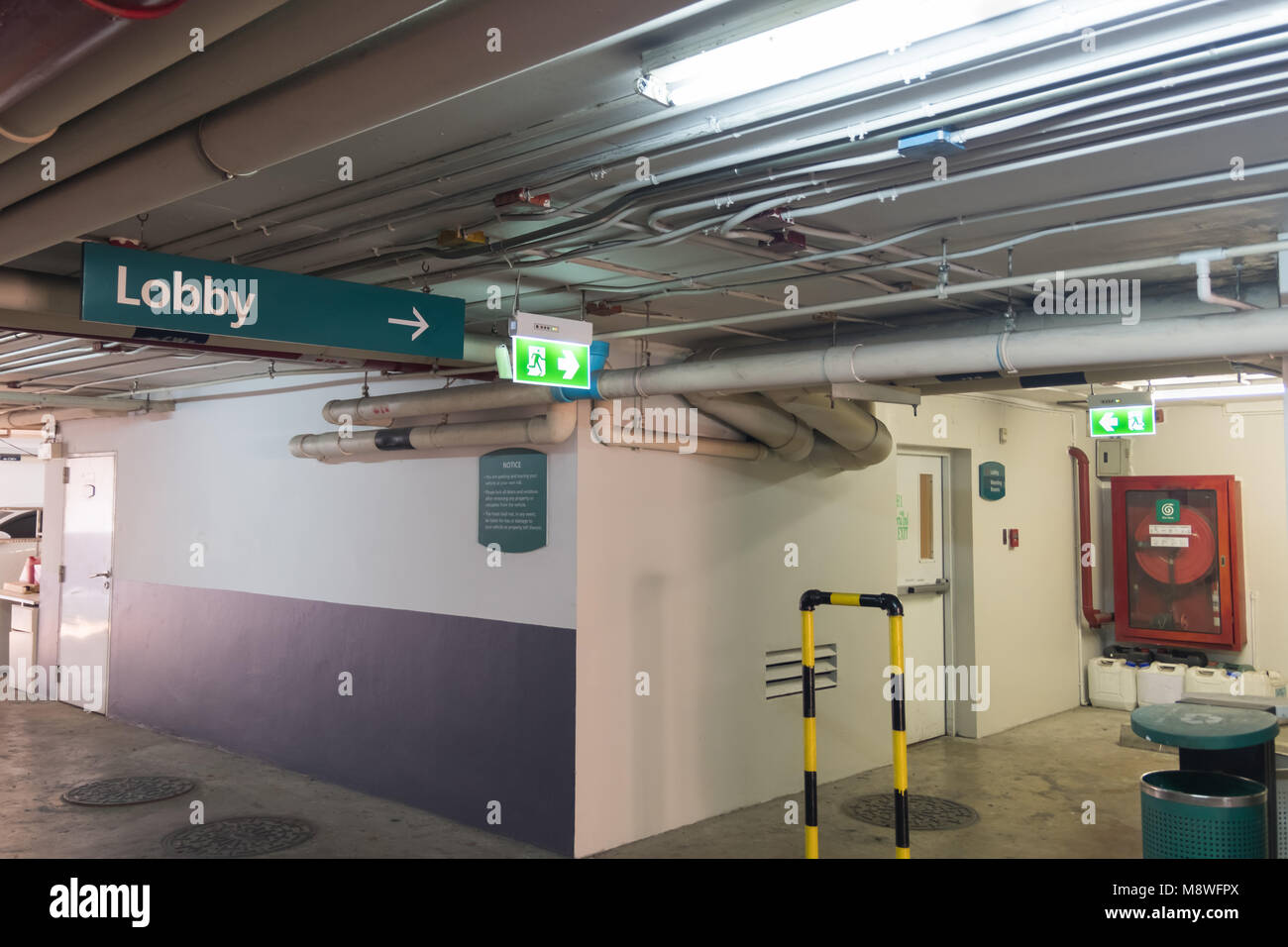 Green emergency exit sign showing the way to escape Stock Photo - Alamy