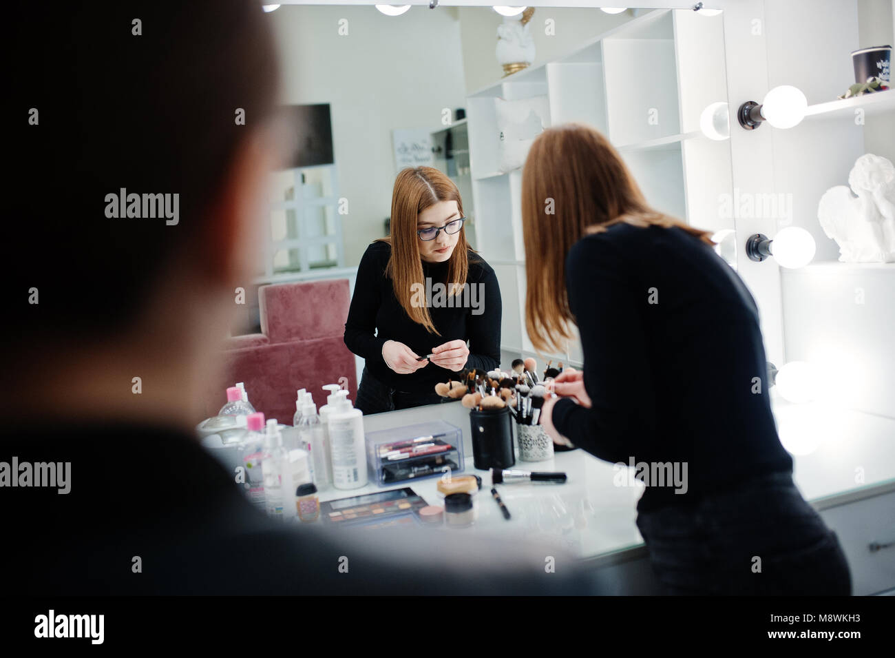 Make up artist work in her beauty visage studio salon. Woman applying ...