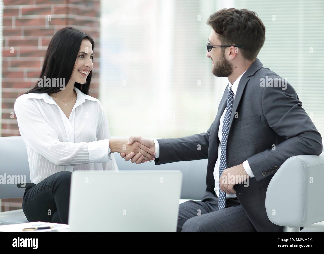 handshake of manager and client sitting in the office lobby Stock Photo ...