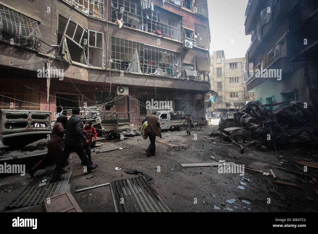 Douma, Syria. 20th Mar, 2018. A family flees from their home after ...