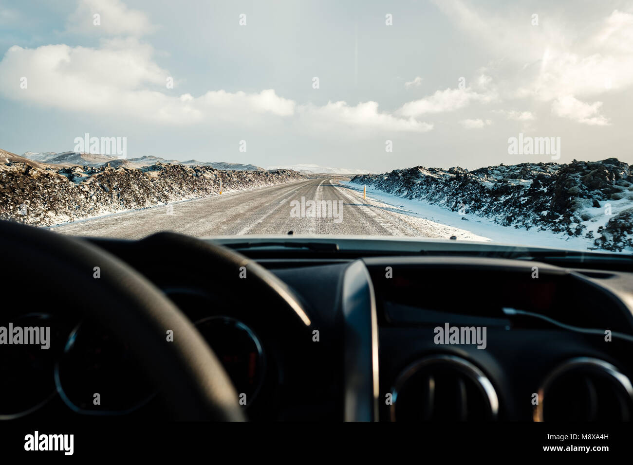 Driving in icelandic winter. Blowing snow across the road. Difficult ...