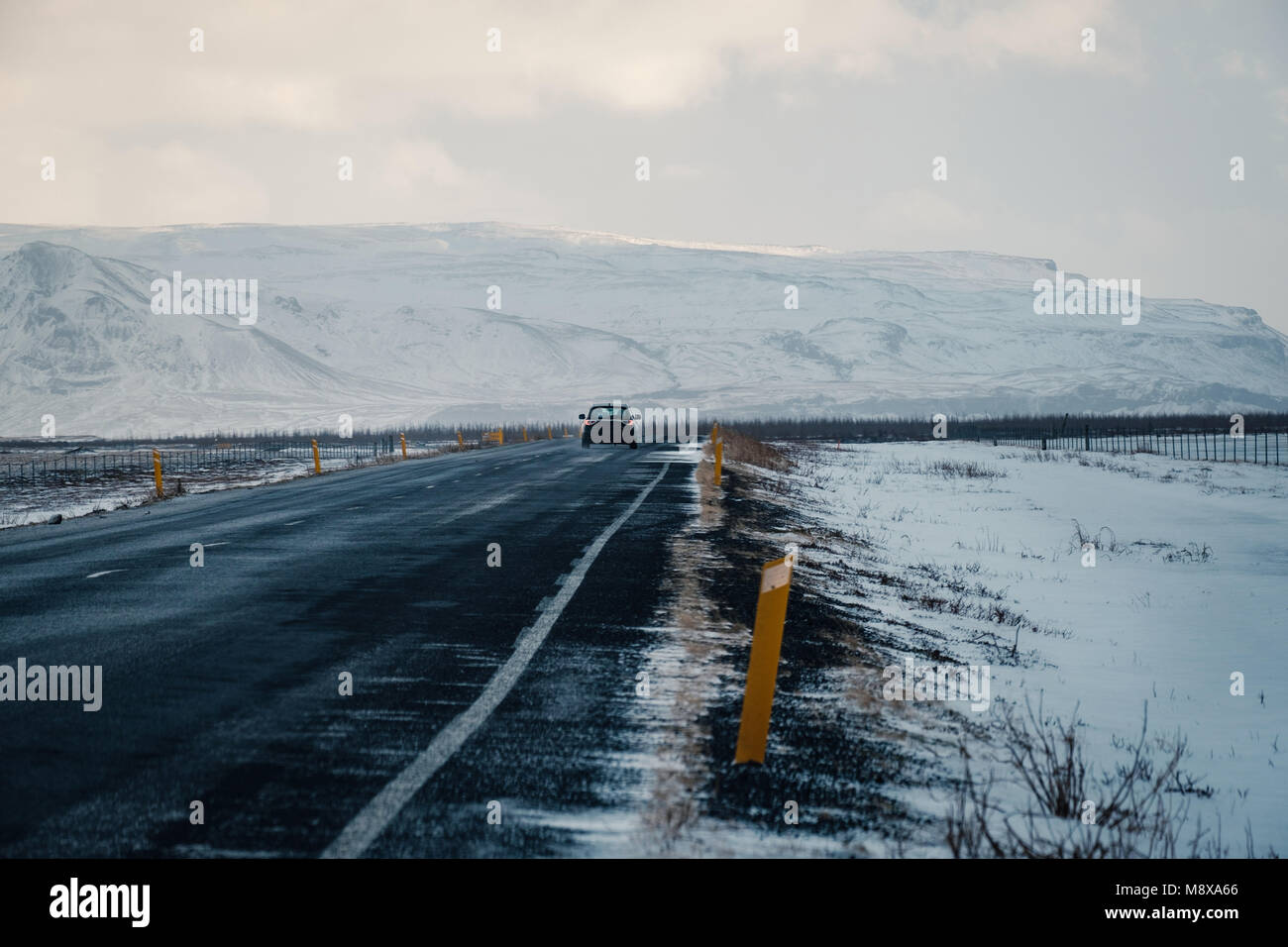 Winter road in snow blizzard. Blowing snow across the road. Difficult ...