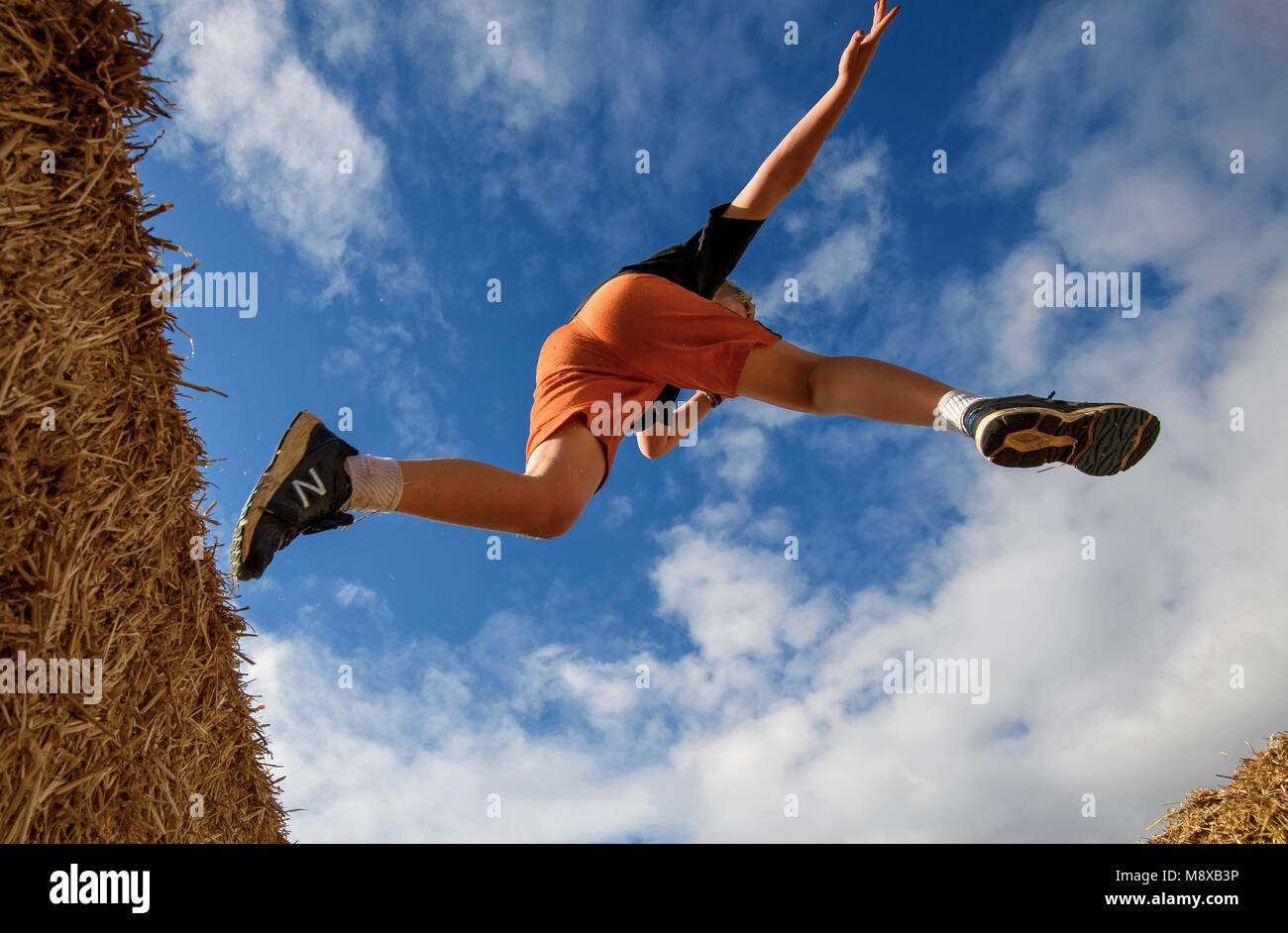 Boy jumping straw bales at Thanksgiving season Stock Photo - Alamy