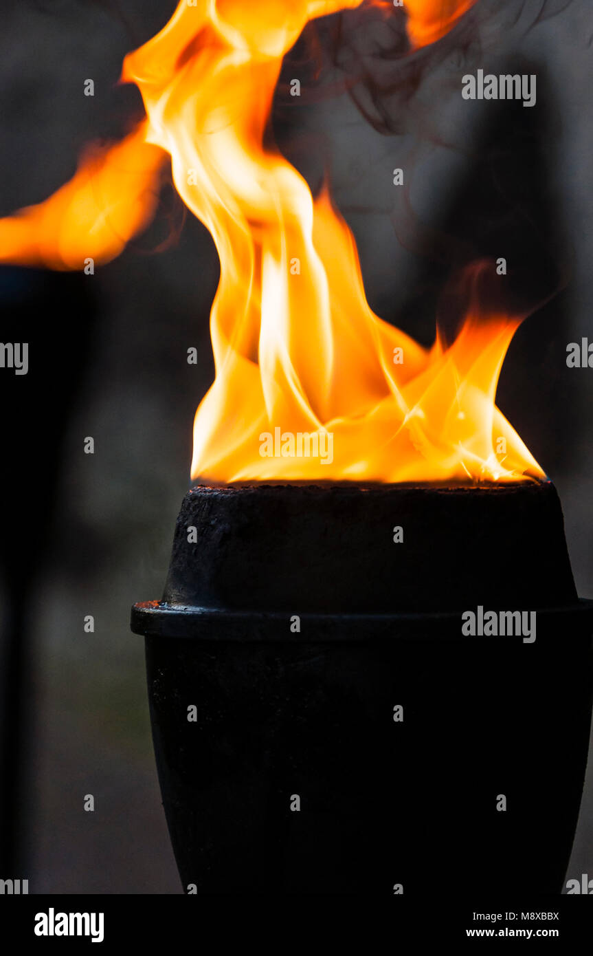 Oil flaming black metal torch. Medieval lighting equipment Stock Photo ...