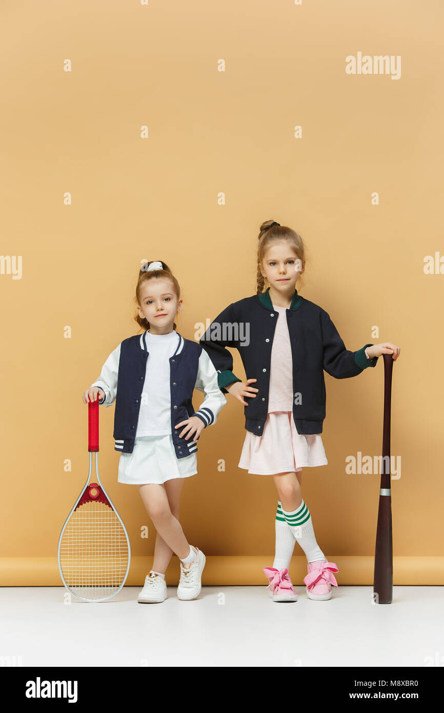 Portrait of two girls as tennis players holding tennis racket. Studio ...