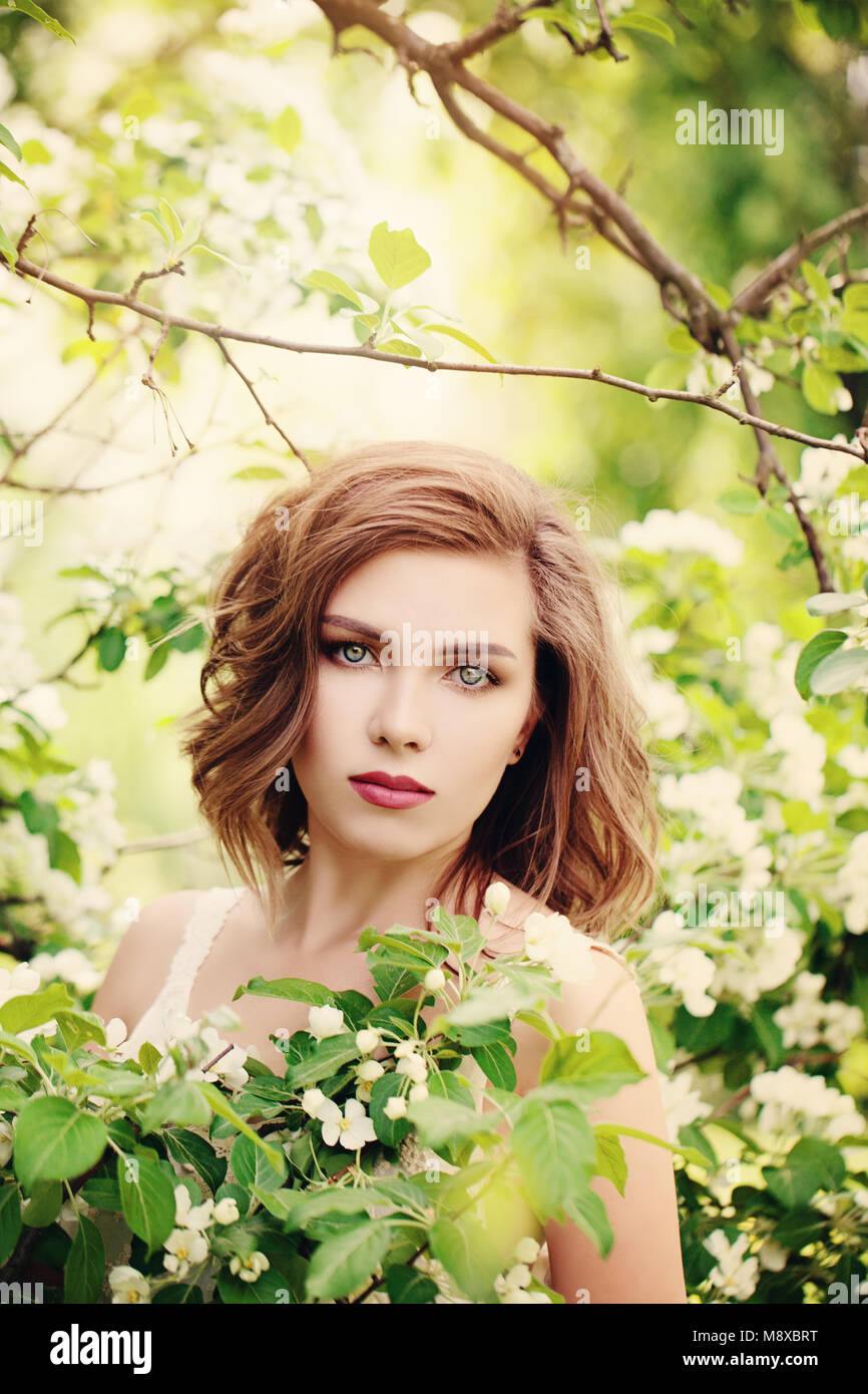 Pretty Girl with Spring Flowers. Fashion Model Outdoors Stock Photo - Alamy